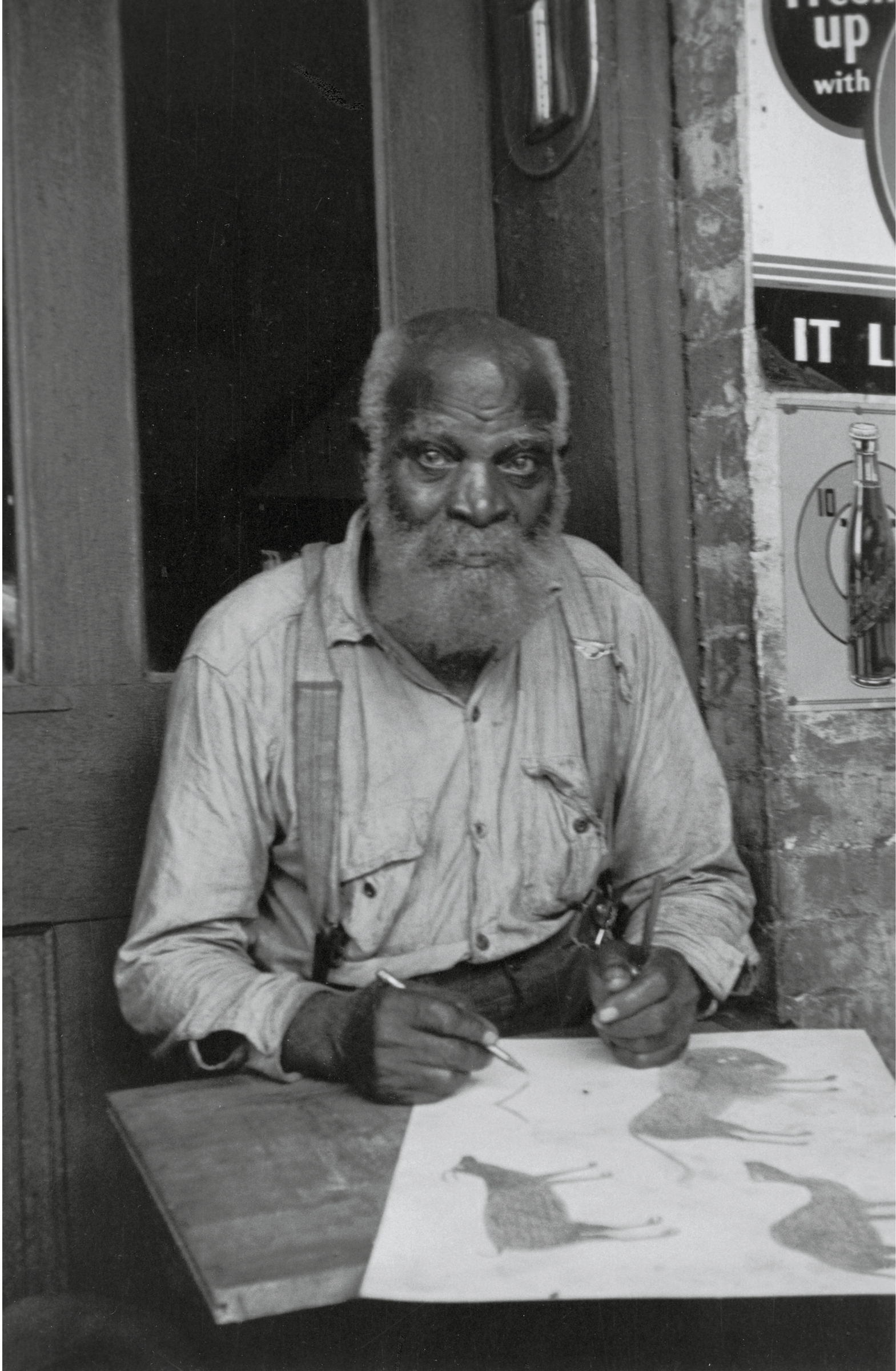 Photographs of Bill Traylor at work document the completion of an ...