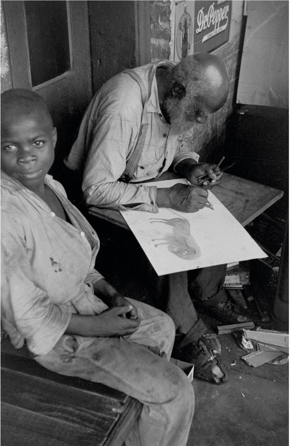 Photographs of Bill Traylor at work document the completion of an ...