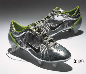 A pair of Nike silver, black and lime green football boots, worn by ...