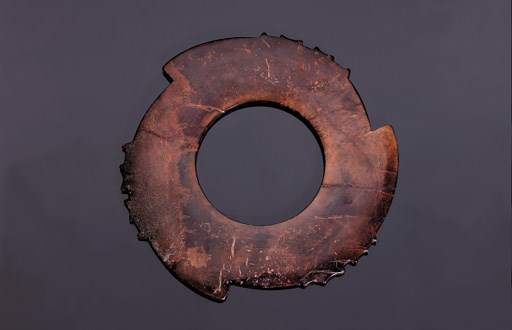 AN ARCHAIC RUSSET AND BROWN JADE NOTCHED DISC, XUANJI , LATE NEOLITHIC ...