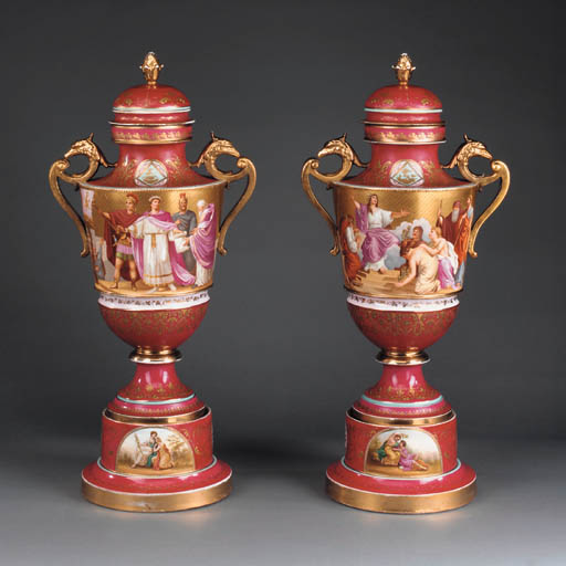 A pair of Vienna parcel-gilt raspberry-ground vases and covers