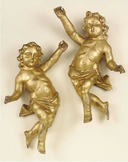 A pair of German or Austrian carved and gilded wall hanging cherubs ...