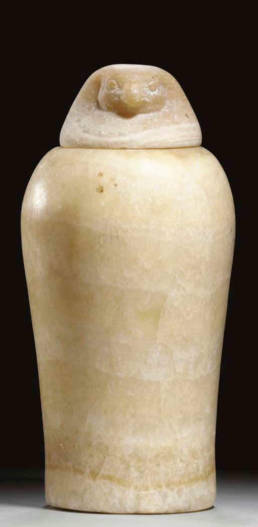 AN EGYPTIAN CALCITE-ALABASTER CANOPIC JAR AND LID , LATE PERIOD ...