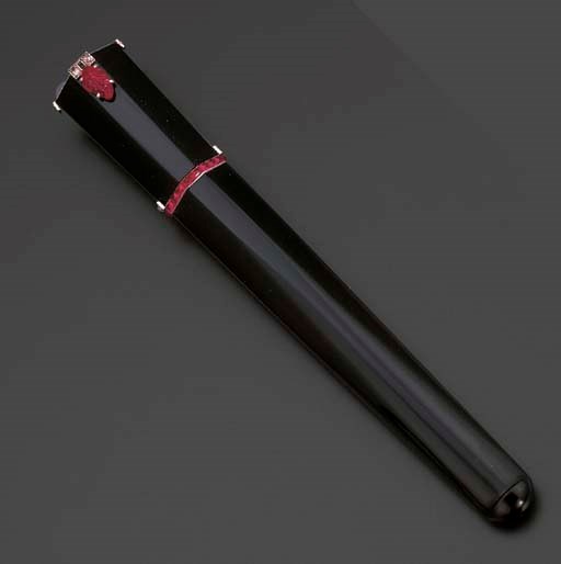 AN ART DECO RUBY AND DIAMOND CIGARETTE HOLDER, BY CARTIER | Christie's