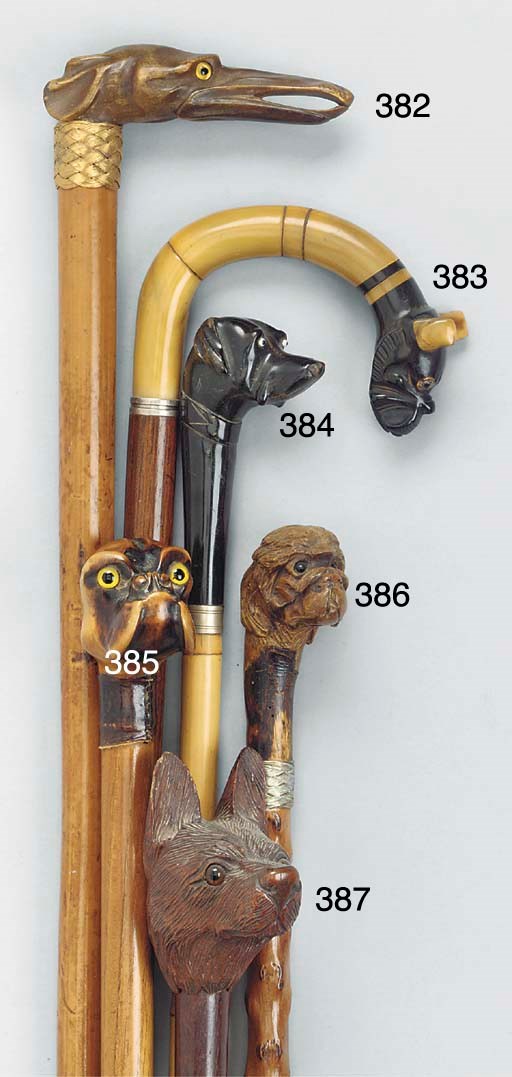 A carved wood mounted gnarled wood walking stick , LATE 19TH CENTURY ...
