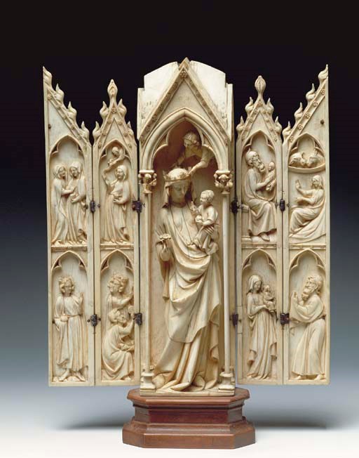 A CARVED IVORY POLYPTYCH CENTRED BY A GROUP OF THE VIRGIN AND CHILD