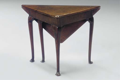 A mahogany triangular drop-leaf table