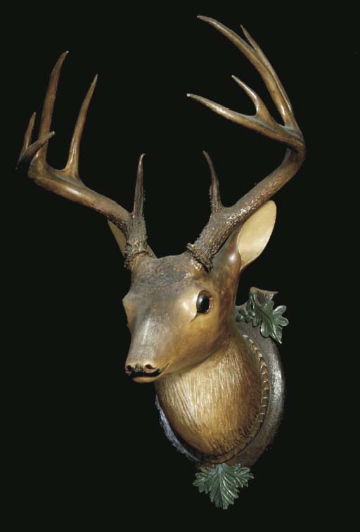 A CARVED AND POLYCHROME-DECORATED TEN-POINT STAGS HEAD
