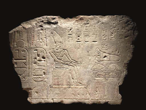 AN EGYPTIAN SANDSTONE RELIEF WITH ATUM AND CARTOUCHES OF TWO DIVINE ...