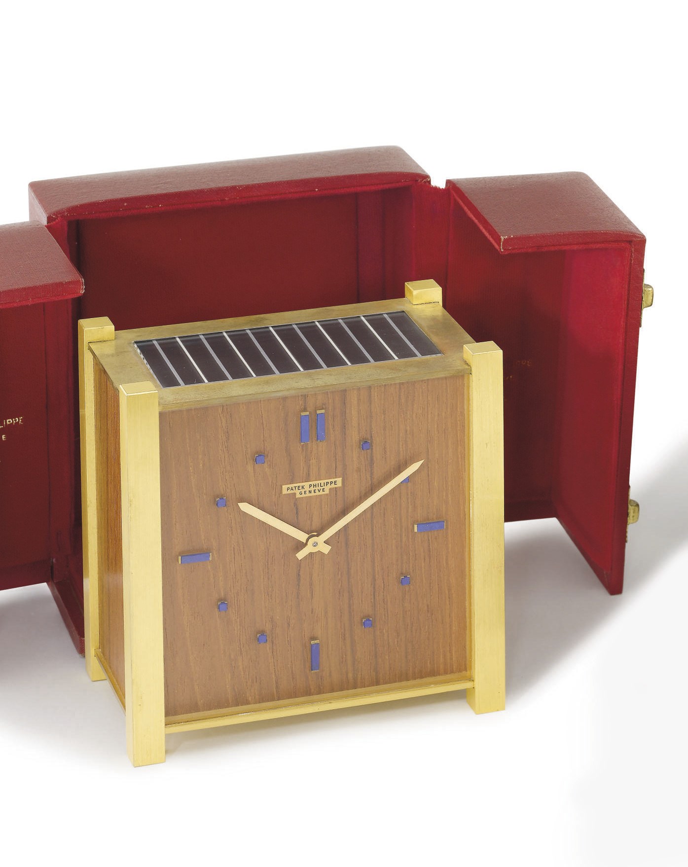 Patek Philippe. A fine gilt brass and veneered teak wood square solar ...