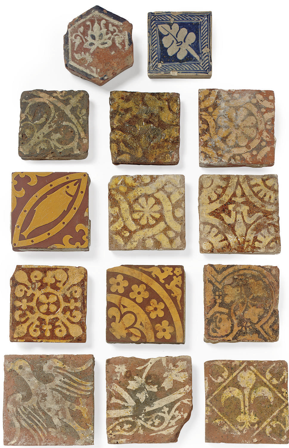 ELEVEN ENCAUSTIC DECORATED RED-CLAY TILES, A SPANISH MAIOLICA BLUE AND ...
