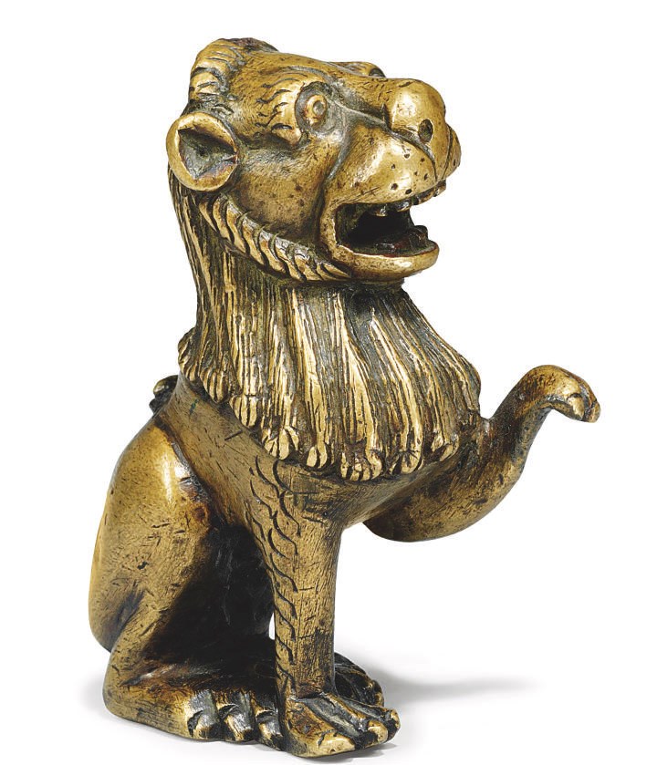 A GERMAN BRONZE MODEL OF A SEATED LION