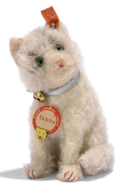 A STEIFF WOOL PLUSH TABBY, seated, white and grey striped, green and ...