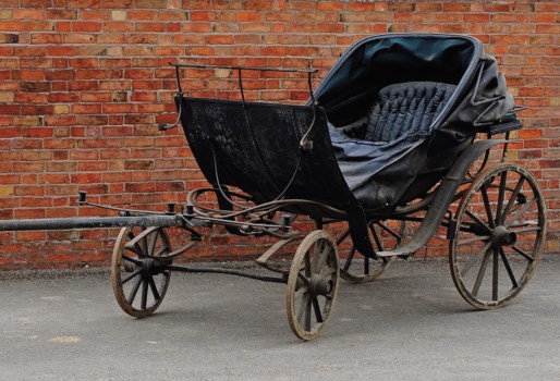 A LATE VICTORIAN DARK GREEN-JAPANNED AND LIVERY-PAINTED LADY'S PHAETON ...