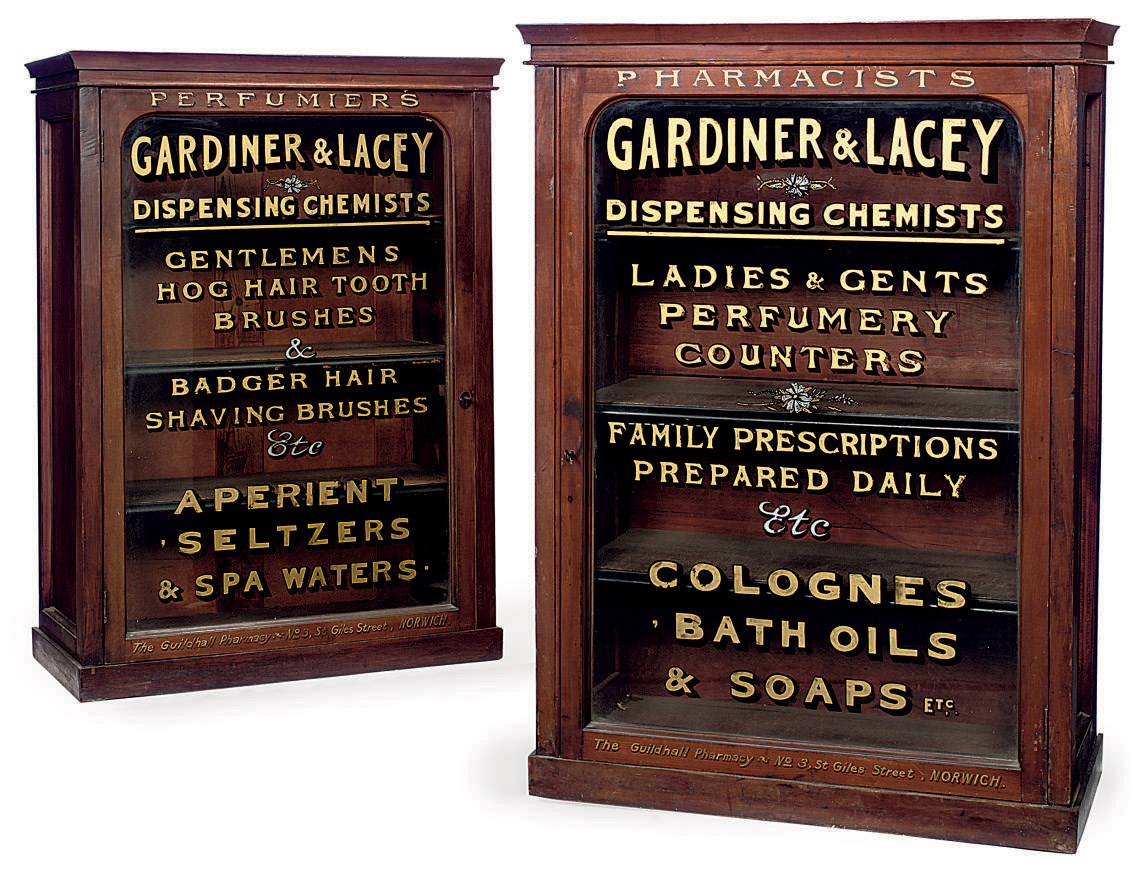 A NEAR PAIR OF ADVERTISING-PAINTED, GLAZED, WALNUT SHOP CABINETS , OF ...