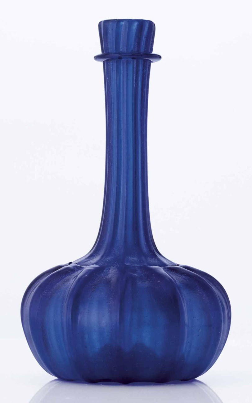 A RARE MOULDED TRANSPARENT BLUE GLASS RIBBED BOTTLE VASE