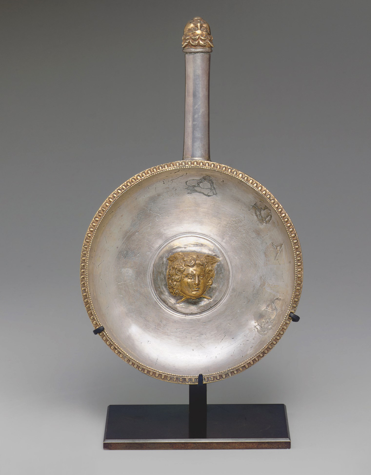 A GREEK PARCEL GILT SILVER PATERA , LATE CLASSICAL TO EARLY HELLENISTIC ...
