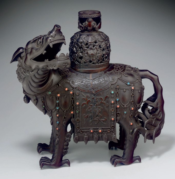 AN UNUSUAL GLASS-INLAID BRONZE CENSER IN THE FORM OF A MYTHICAL BEAST ...