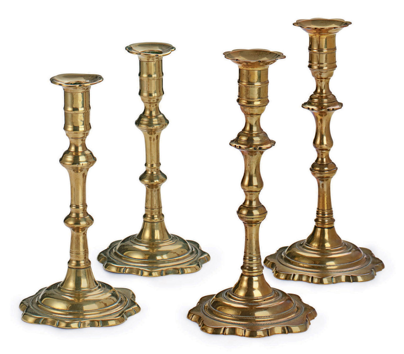 TWO PAIRS OF GEORGE II CAST BRASS CANDLESTICKS