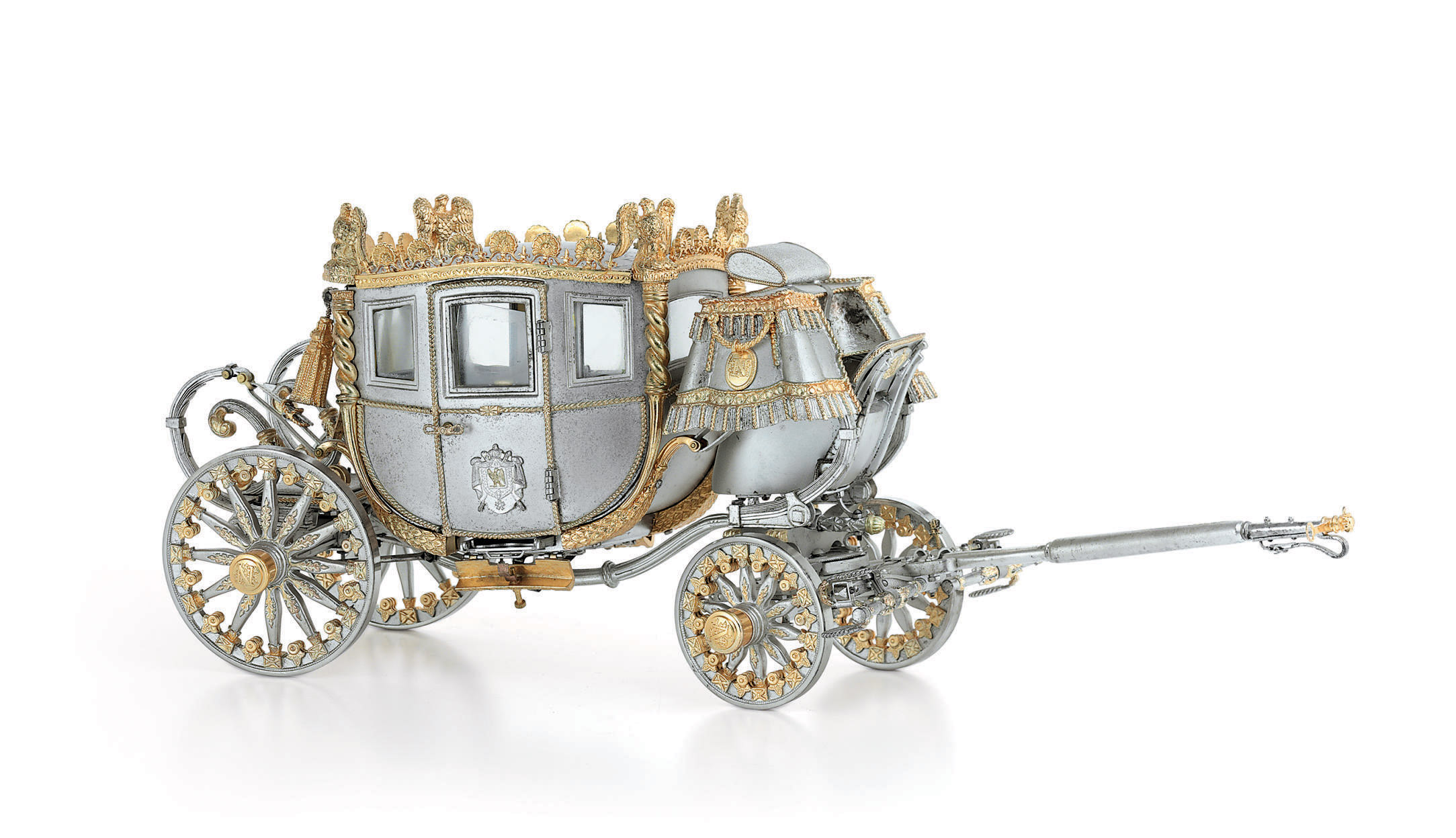 AN AMERICAN PARCEL-GILT SILVER MODEL OF A CORONATION COACH