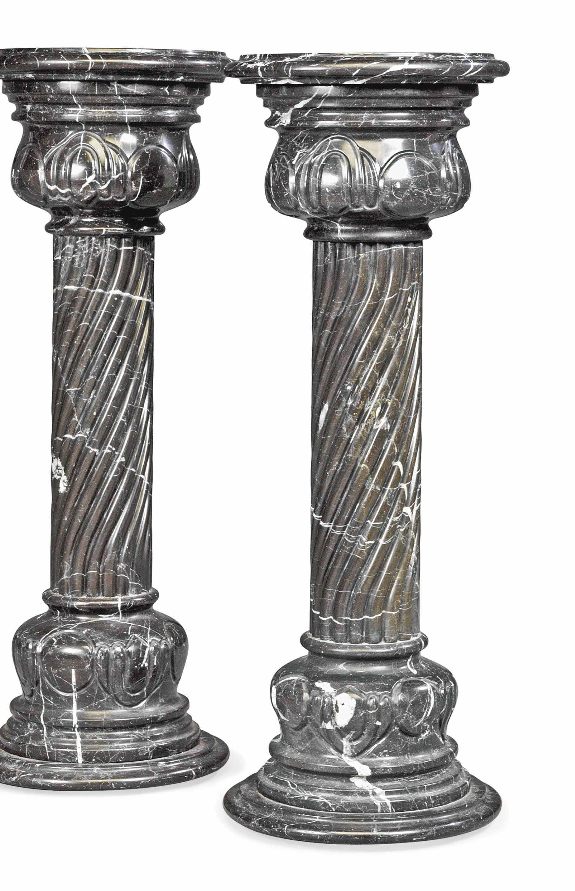 A PAIR OF VARIEGATED BLACK MARBLE PEDESTALS