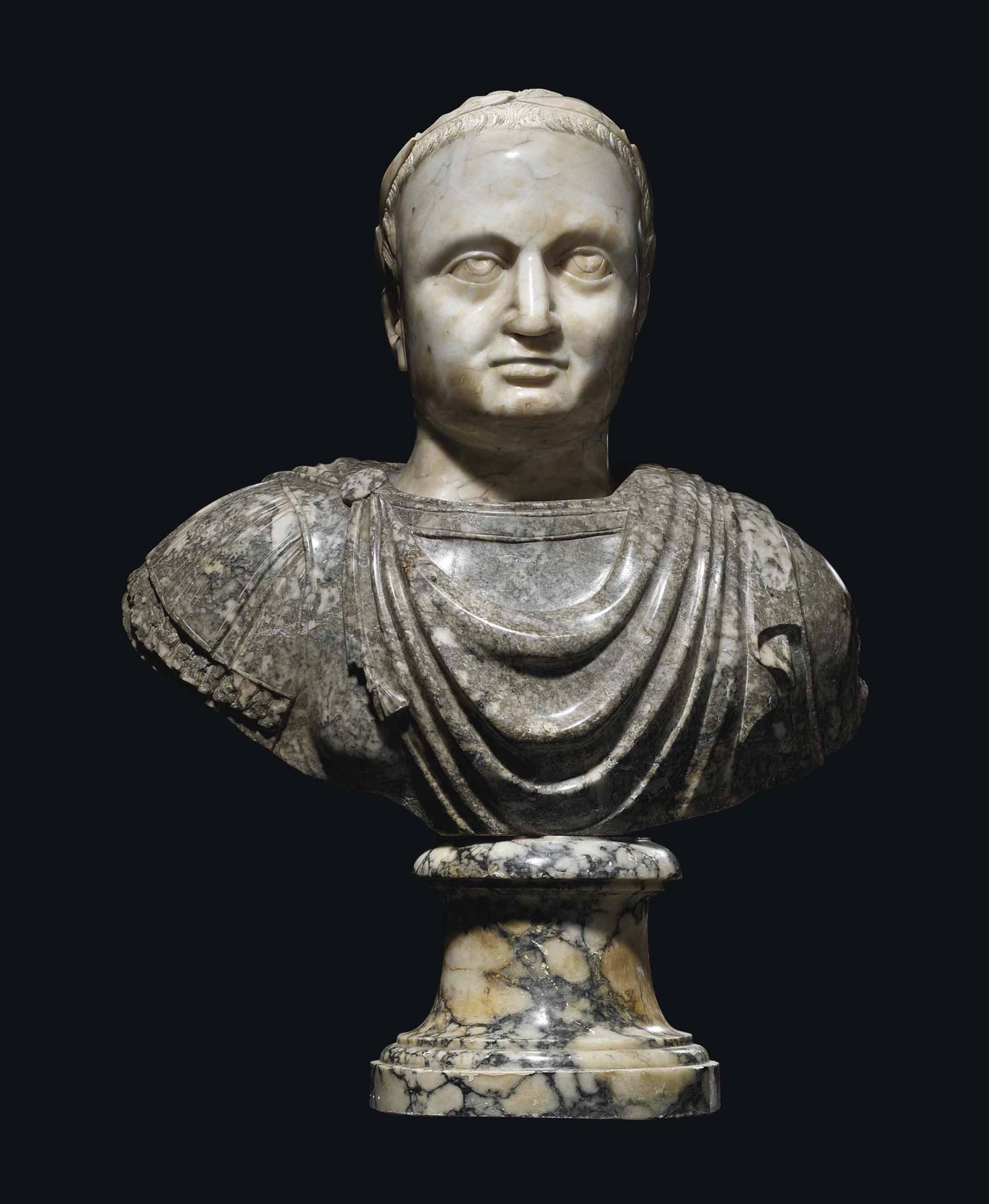 A CARVED MARBLE BUST OF A ROMAN EMPEROR