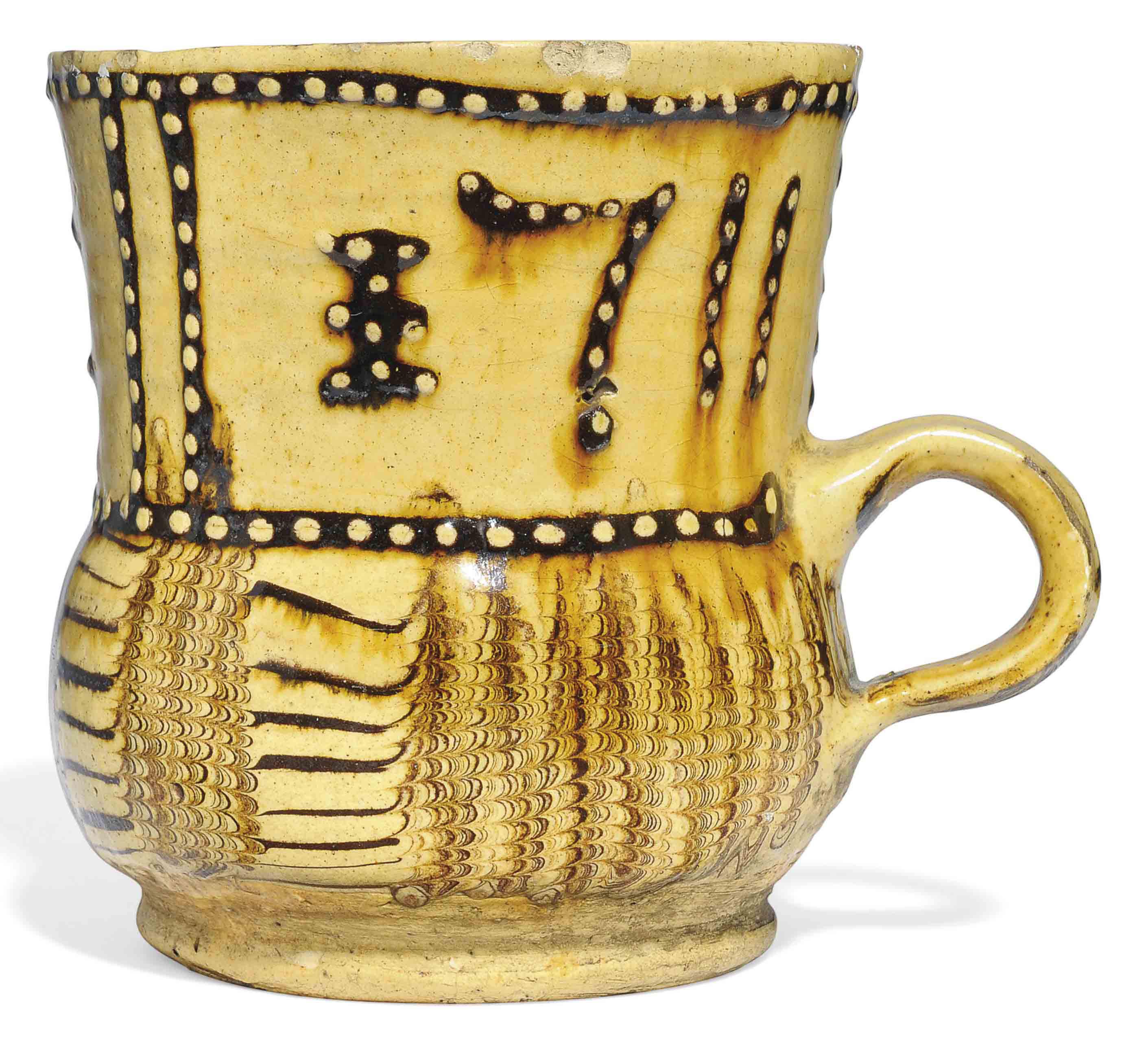 A STAFFORDSHIRE SLIPWARE DATED MUG , 1711 | Christie's
