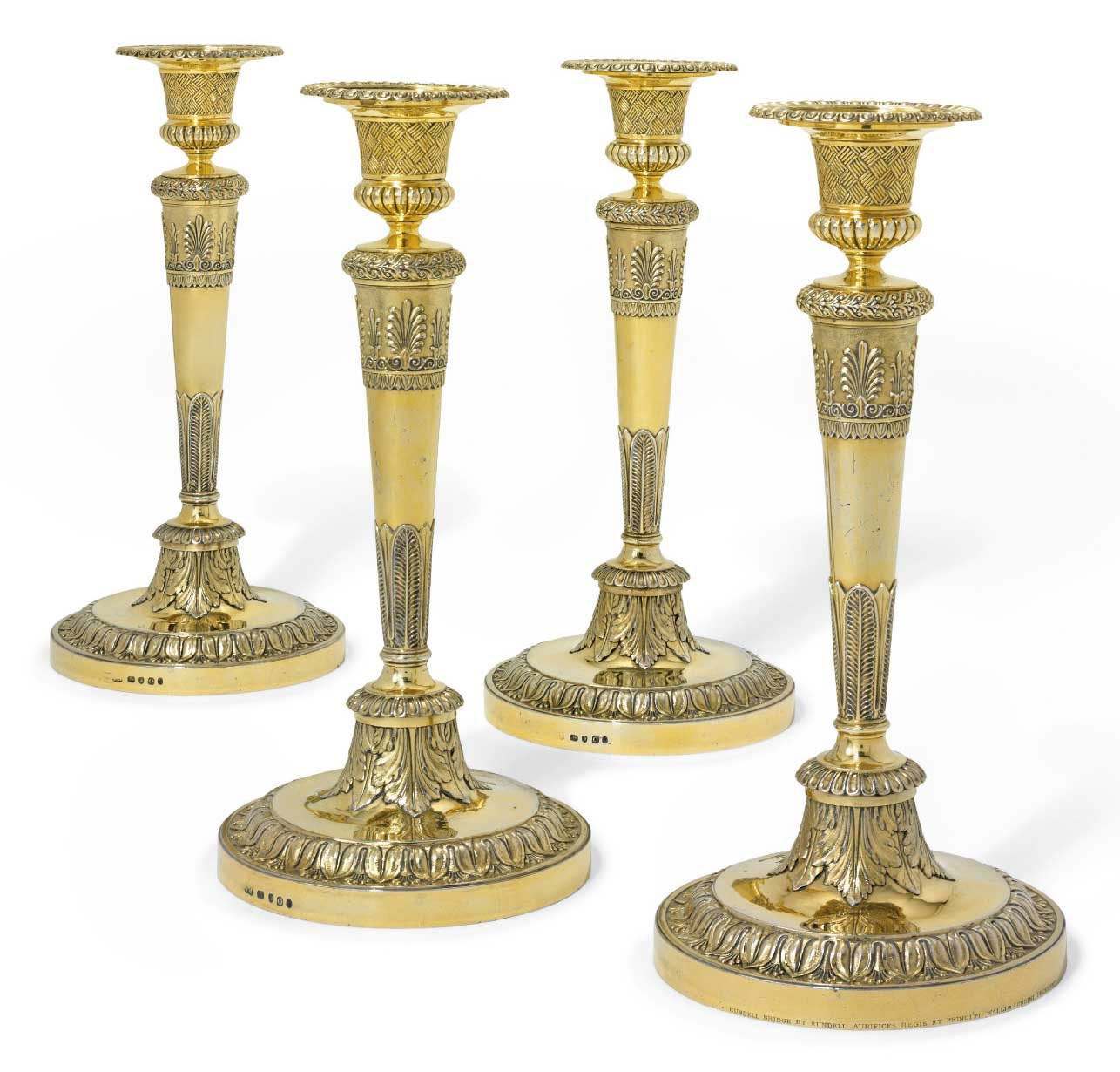 A SET OF FOUR GEORGE III SILVER-GILT CANDLESTICKS