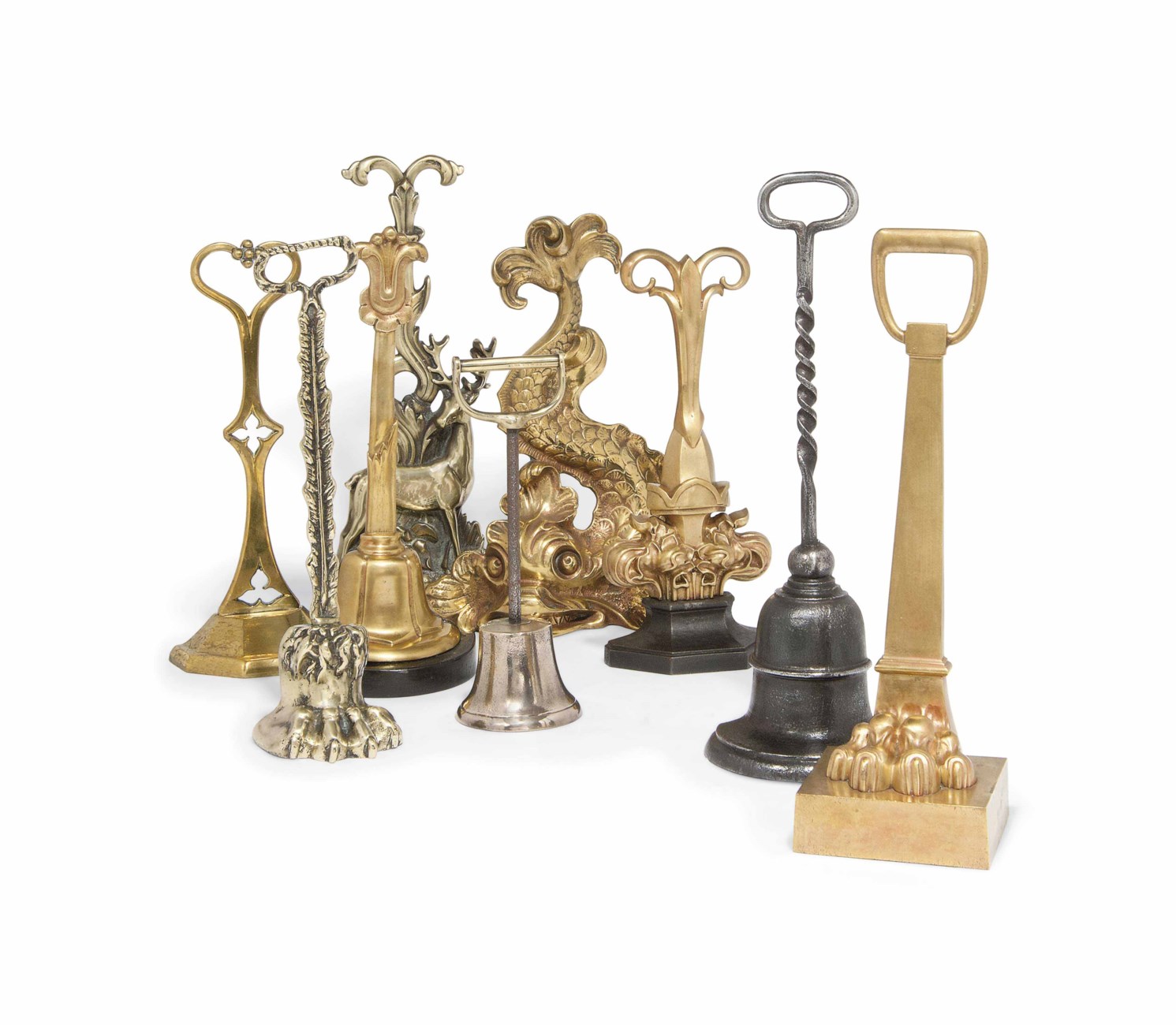 A GROUP OF NINE VICTORIAN AND LATER BRASS DOOR STOPS , LATE 19TH AND ...