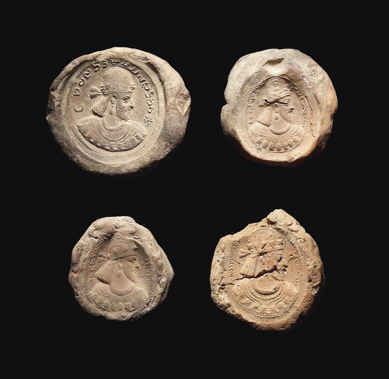 FOUR SASANIAN POTTERY BULLAE