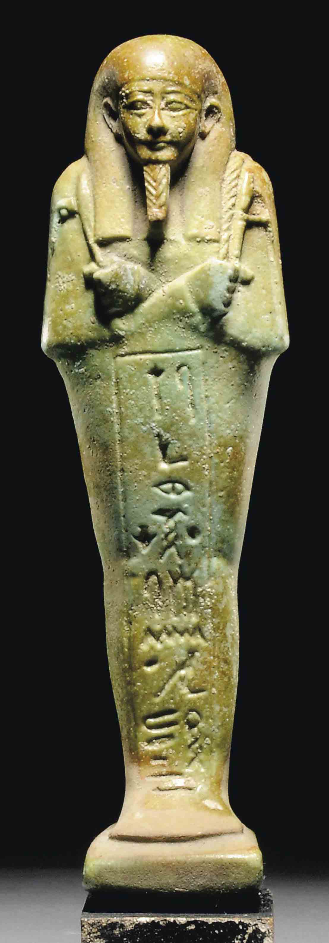 AN EGYPTIAN GREEN GLAZED COMPOSITION SHABTI FOR WAH-IB-RA, BORN OF TA ...