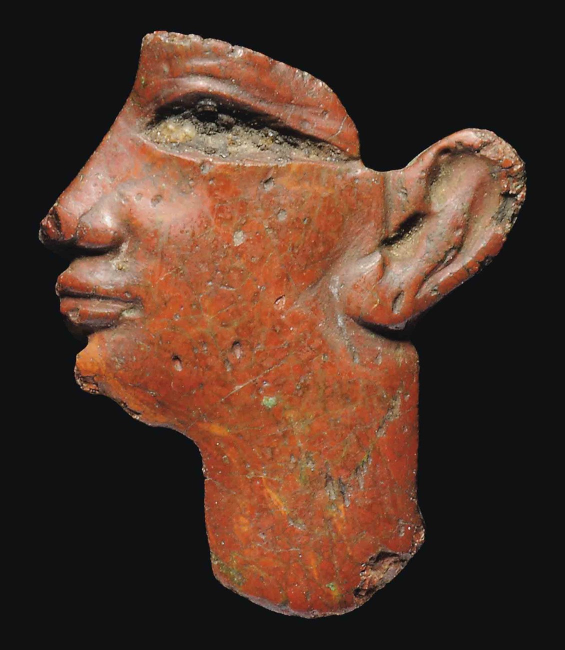AN EGYPTIAN RED JASPER PROFILE FACE INLAY , LATE PERIOD, DYNASTY XXX TO ...