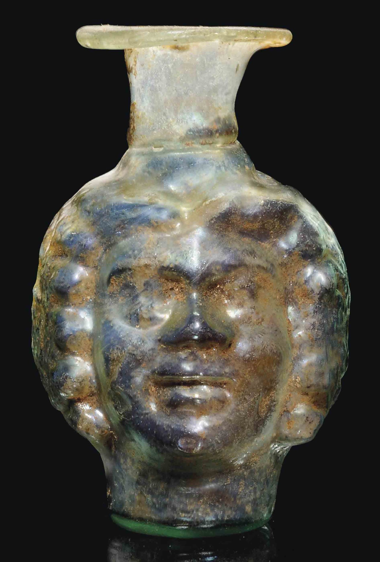 A ROMAN GREEN GLASS JANUS-HEAD FLASK , CIRCA 2ND-3RD CENTURY A.D ...
