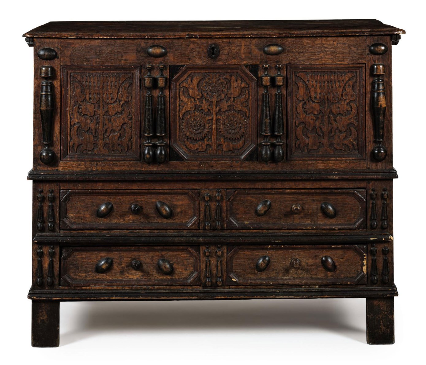 A JOINED AND PAINTED OAK CARVED "SUNFLOWER" CHEST WITH TWO DRAWERS ...