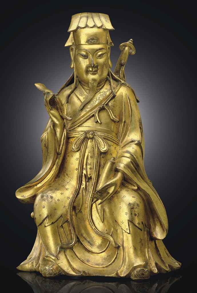 A VERY RARE GILT-BRONZE FIGURE OF LU DONGBIN