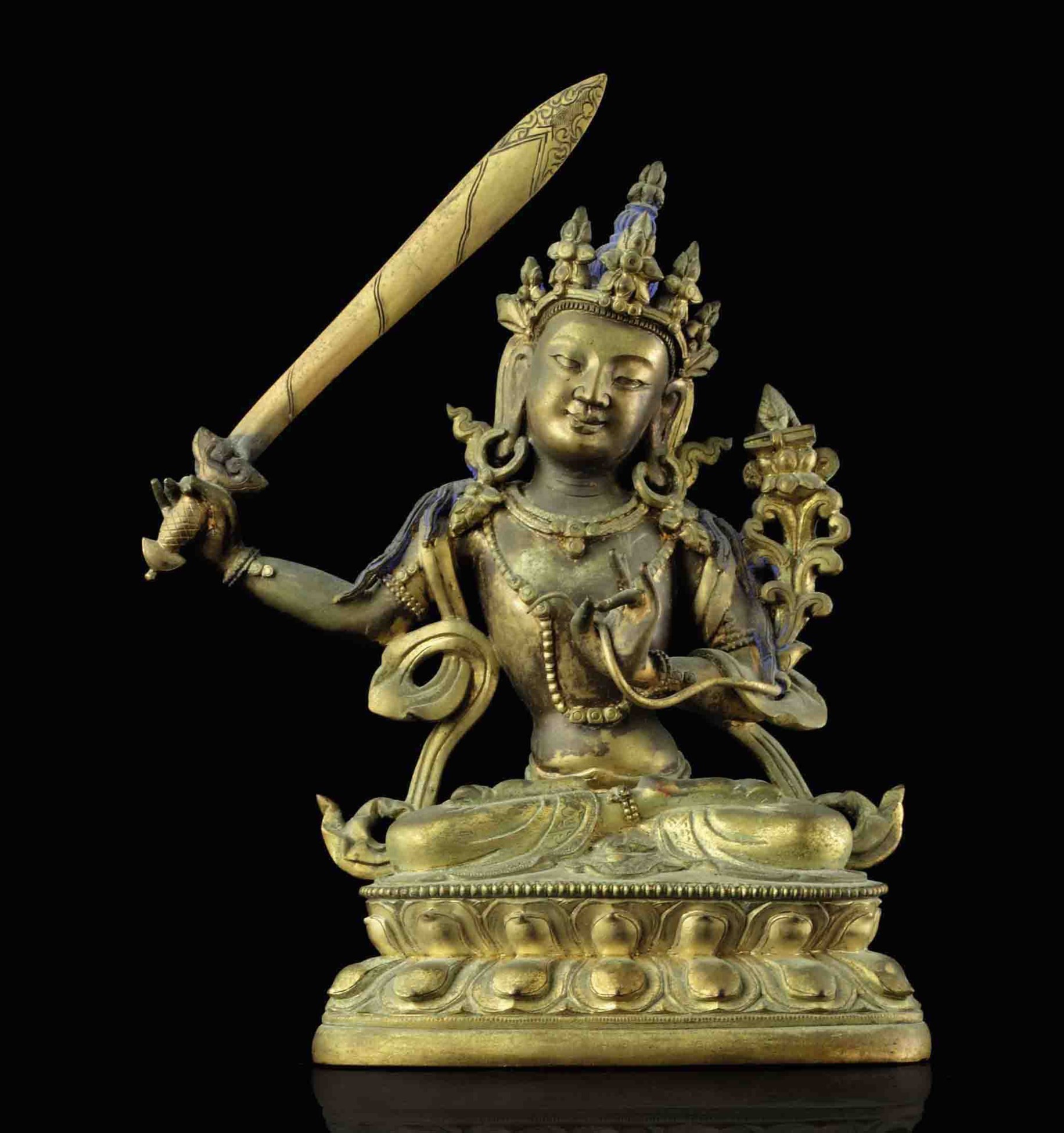 A GILT-BRONZE FIGURE OF MANJUSRI , QIANLONG PERIOD (1736-1795) | Christie's