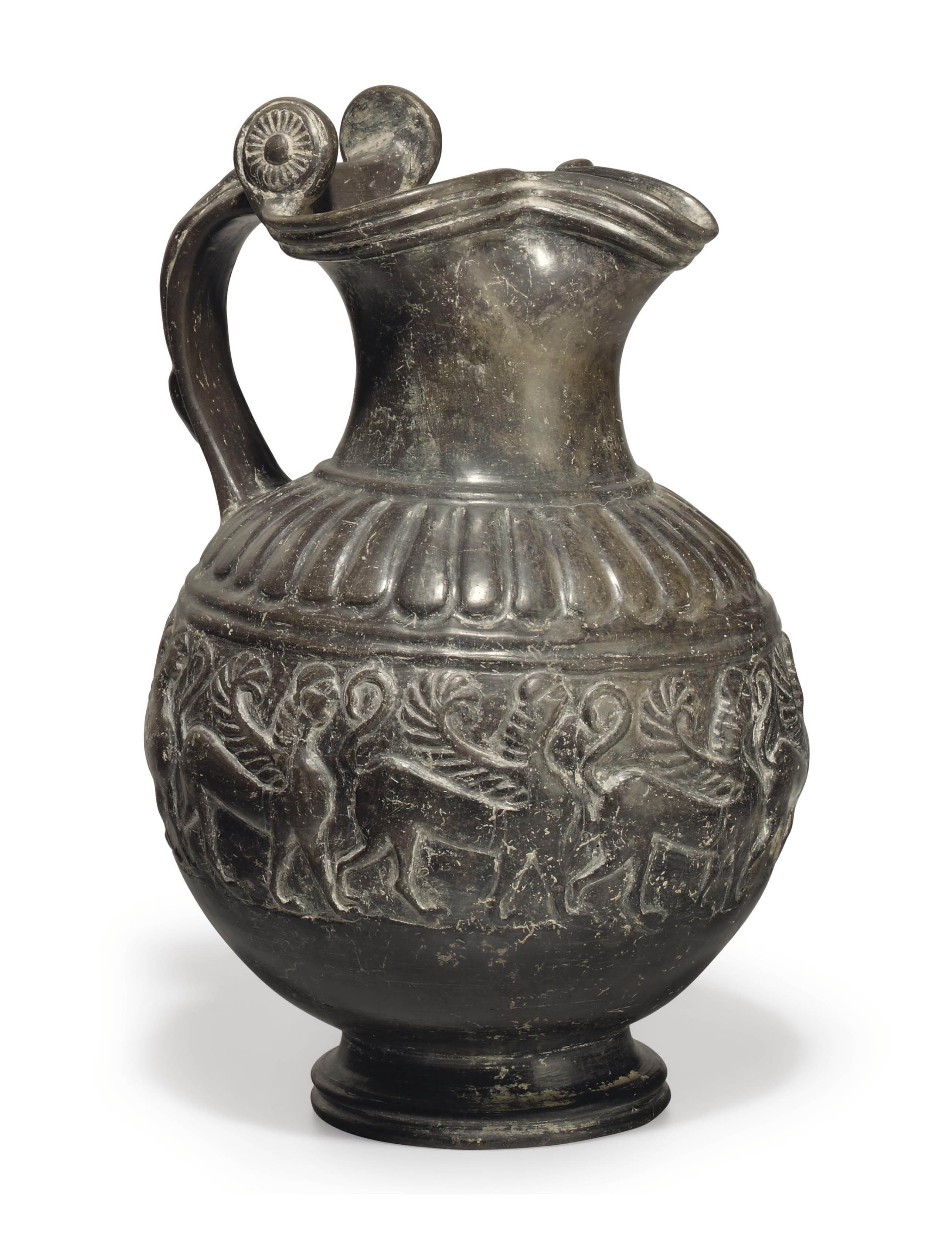 AN ETRUSCAN BUCCHERO PESANTE TREFOIL OINOCHOE , CIRCA MID 6TH CENTURY B ...