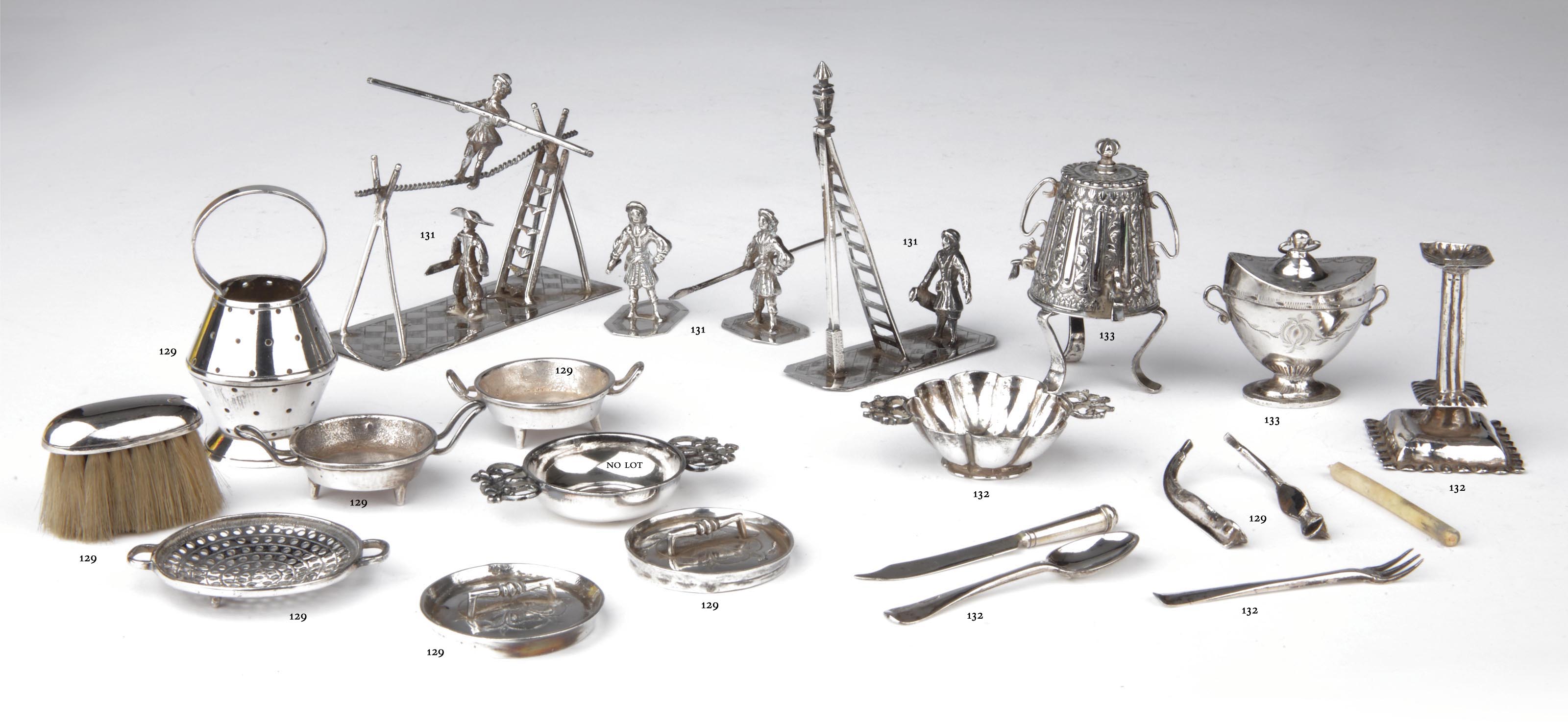 A group of four silver miniature toys