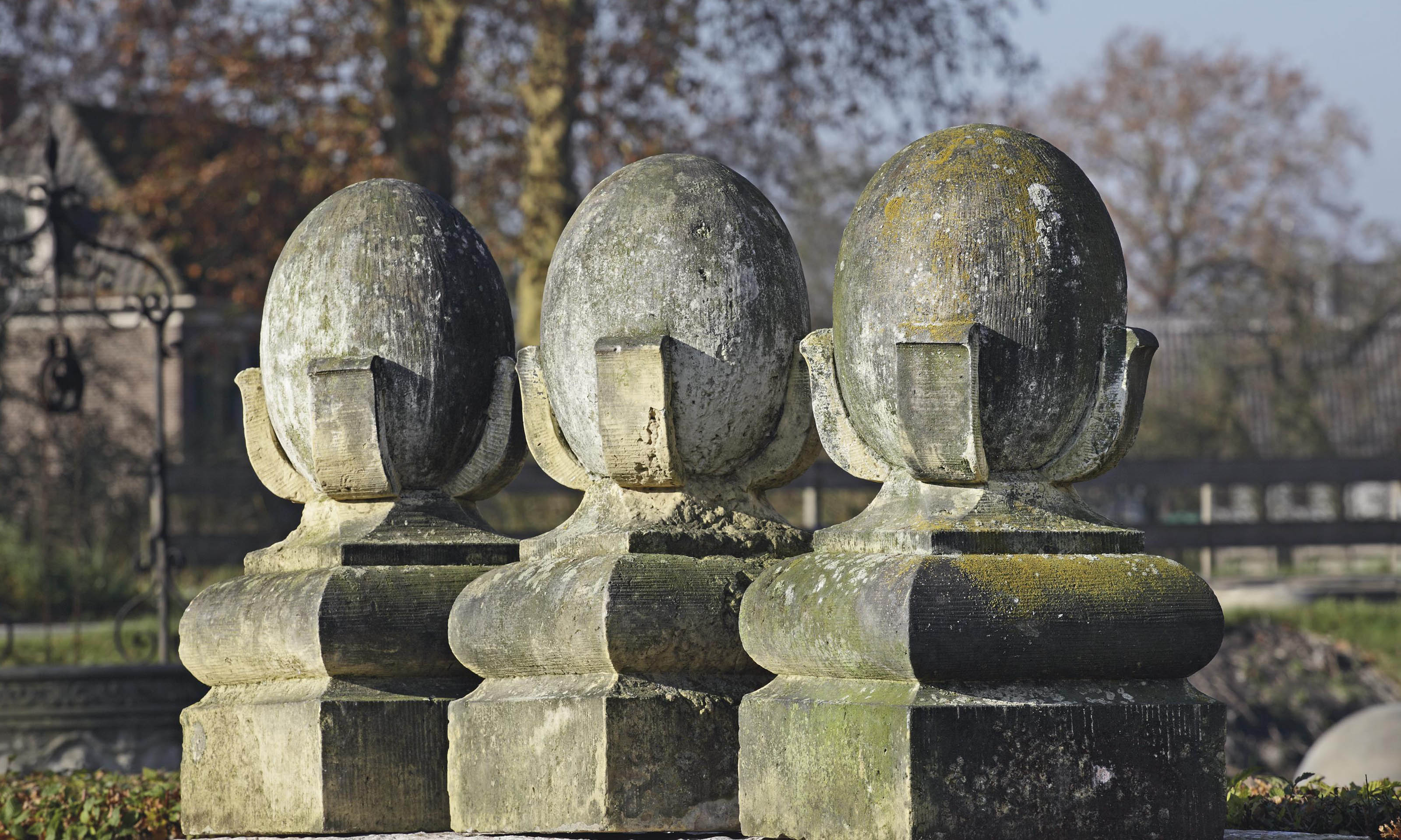 A set of three carved sandstone finials