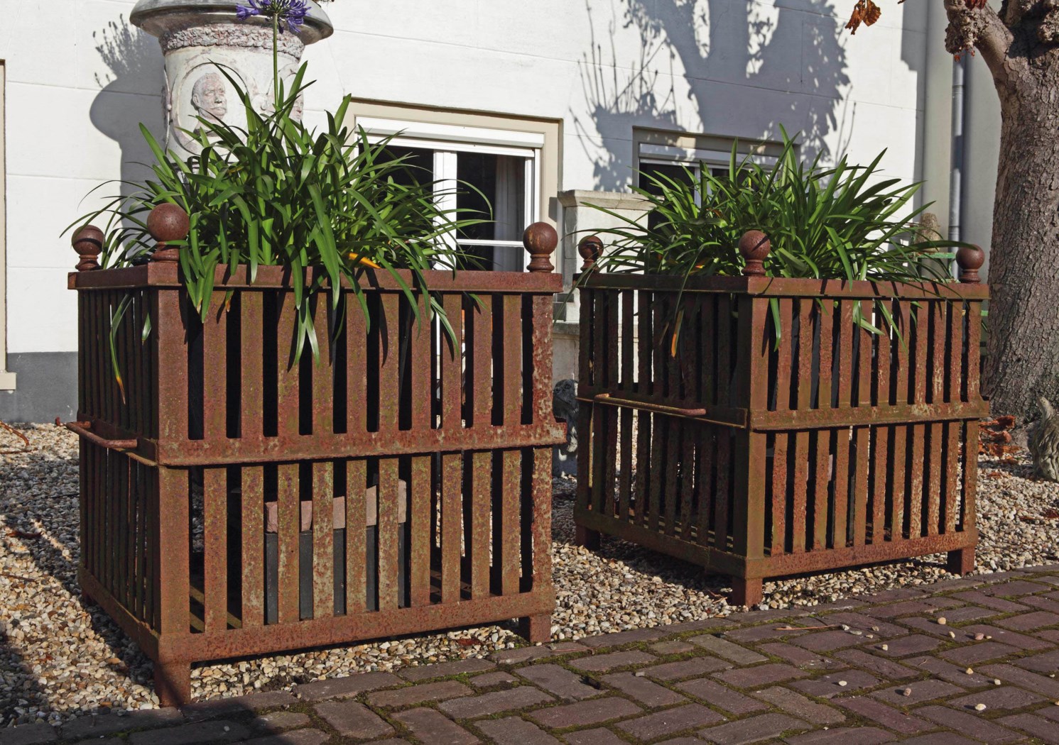 A pair of wrought-iron planters