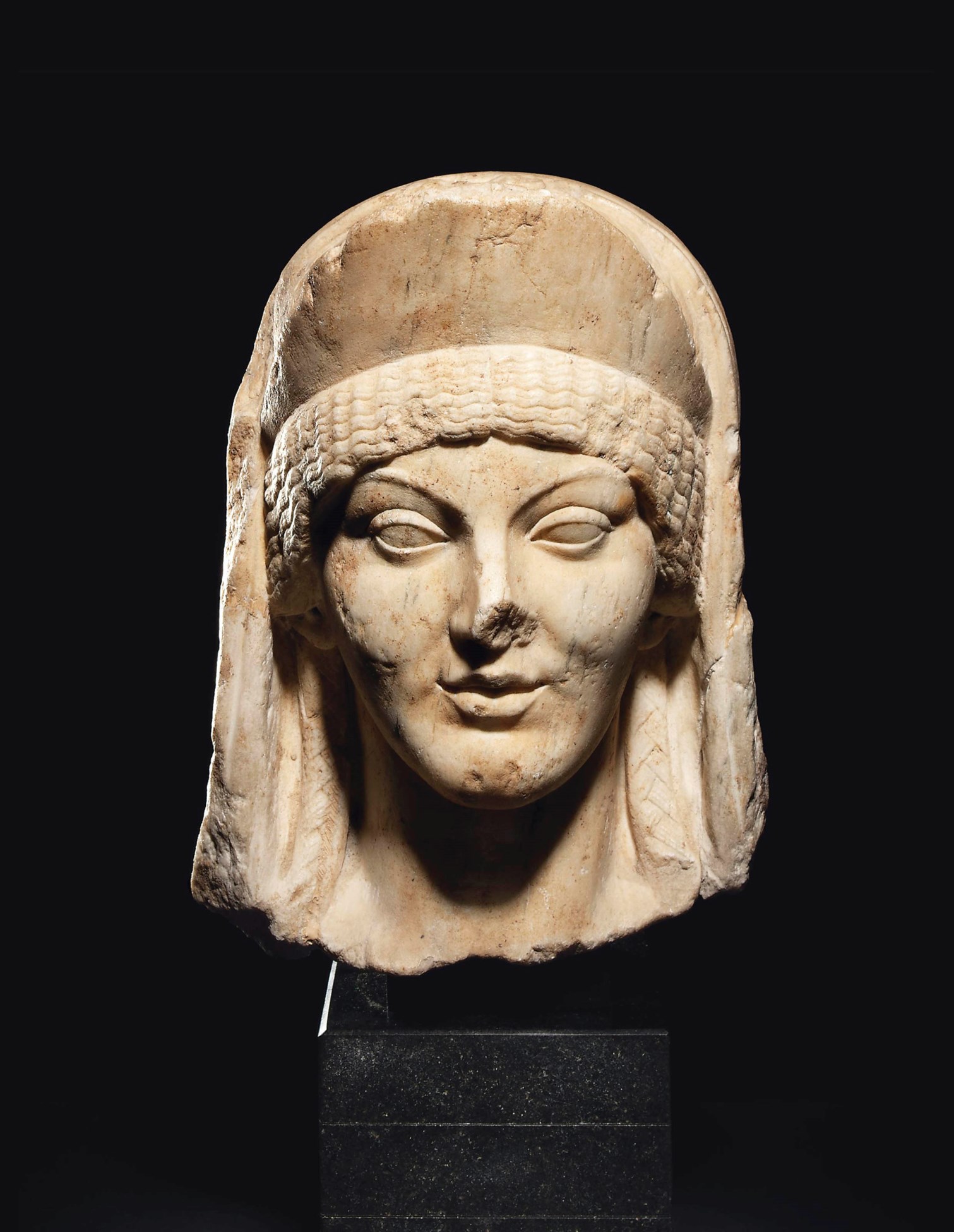 A ROMAN ARCHAISTIC MARBLE FEMALE HERM HEAD