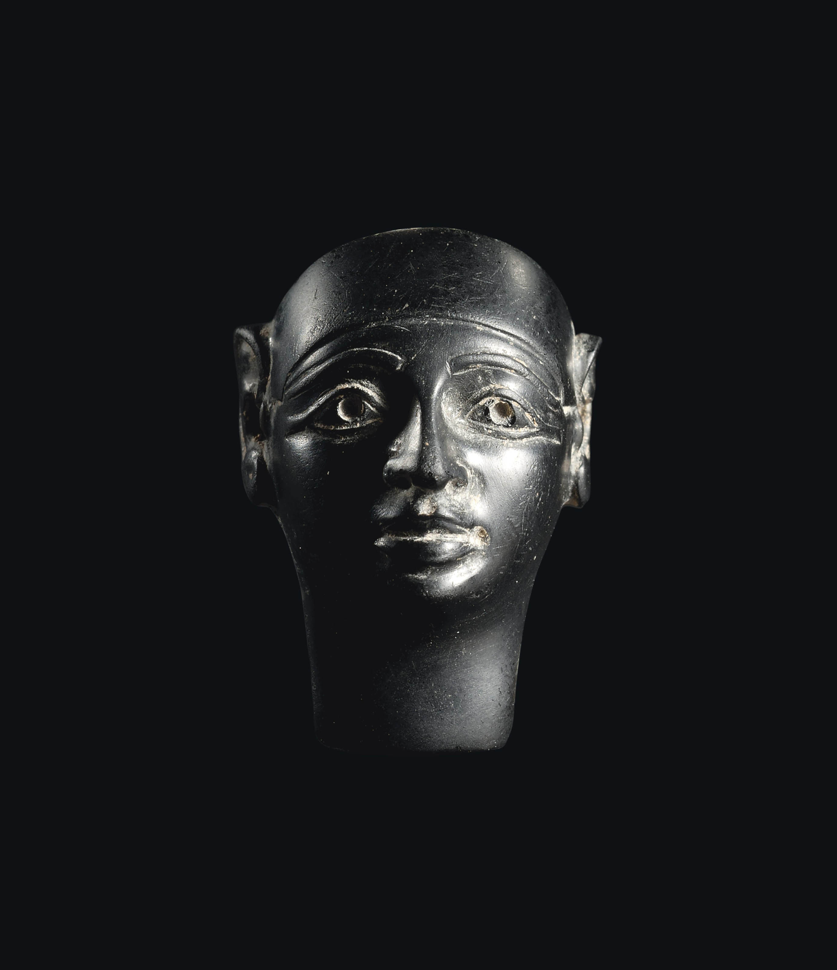 A PHOENICIAN BLACK OBSIDIAN HEAD OF A DIVINITY , CIRCA EARLY 1ST ...