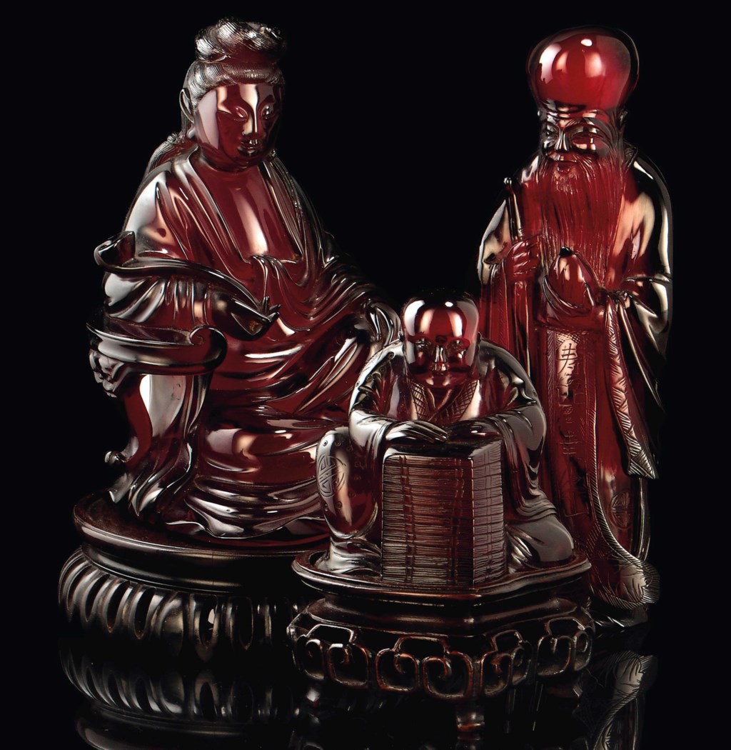 THREE CHINESE PRESSED AMBER FIGURES