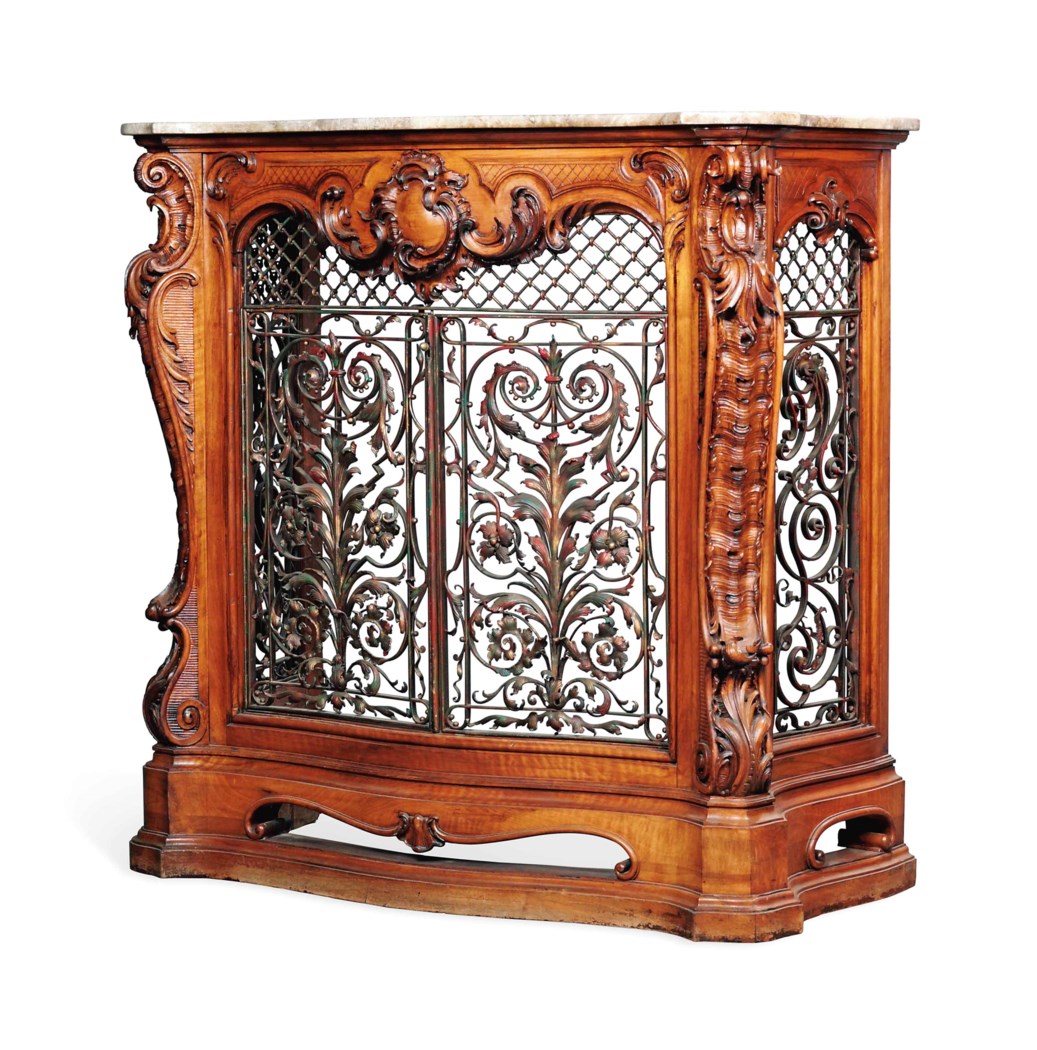 A FRENCH PARCEL-GILT CARVED WALNUT AND GILT WROUGHT-IRON RADIATOR COVER ...