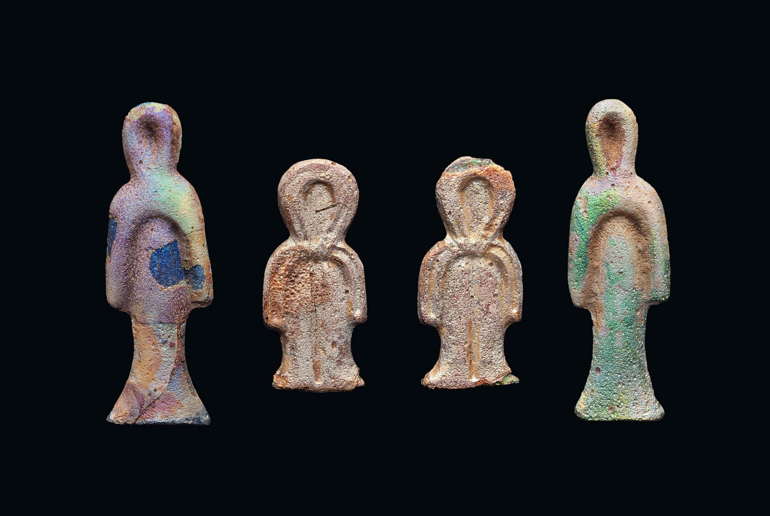 FOUR EGYPTIAN IRIDESCENT GLASS TYET AMULETS , PTOLEMAIC PERIOD, CIRCA ...
