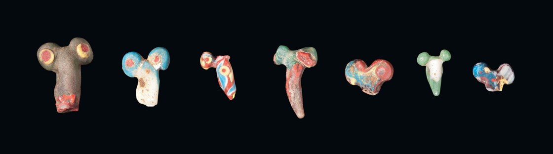 EIGHT EGYPTIAN GLASS PHALLIC AMULETS , PTOLEMAIC PERIOD, CIRCA 3RD-1ST ...