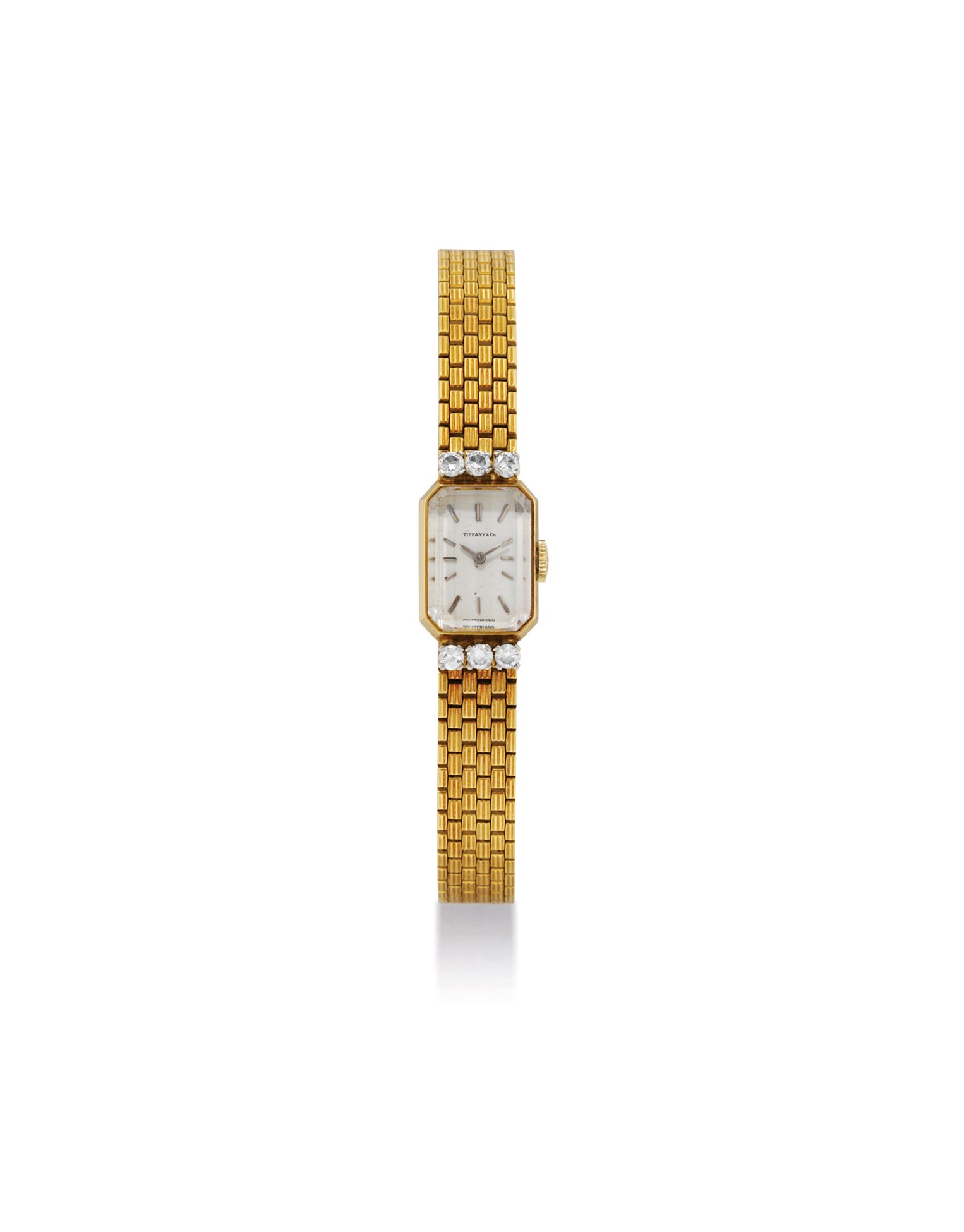 MOVADO. A LADY'S 18K GOLD AND DIAMOND-SET CUT-CORNERED RECTANGULAR ...