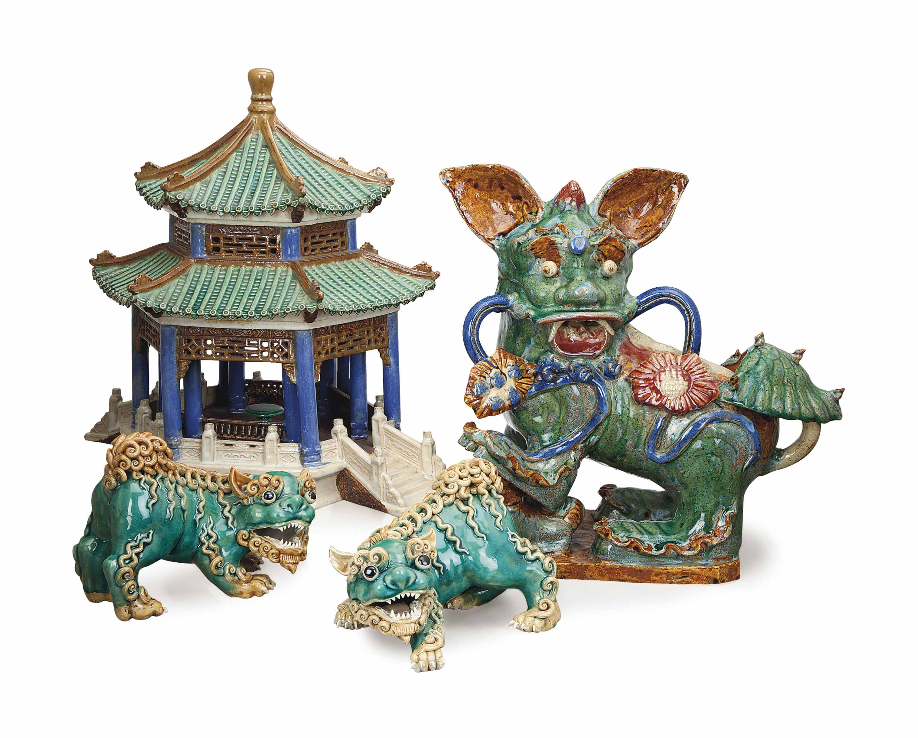 A CHINESE GLAZED POTTERY PAGODA AND THREE BUDDHISTIC LIONS,