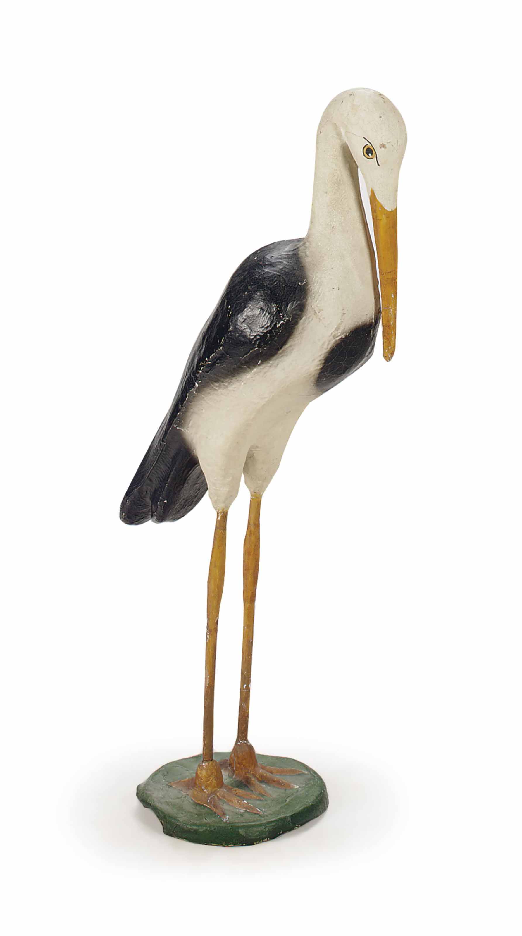 A POLYCHROME-DECORATED CARVED WOOD FIGURE OF A STORK,