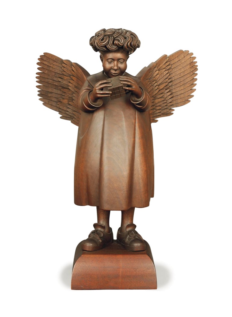 A CARVED MAHOGANY FIGURE OF AN ANGEL WITH A RUBIK'S CUBE, , LATE 20TH ...